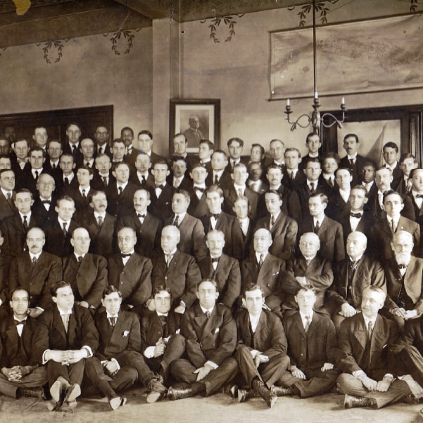 big group of massmutual men posing for photo in professional uniform